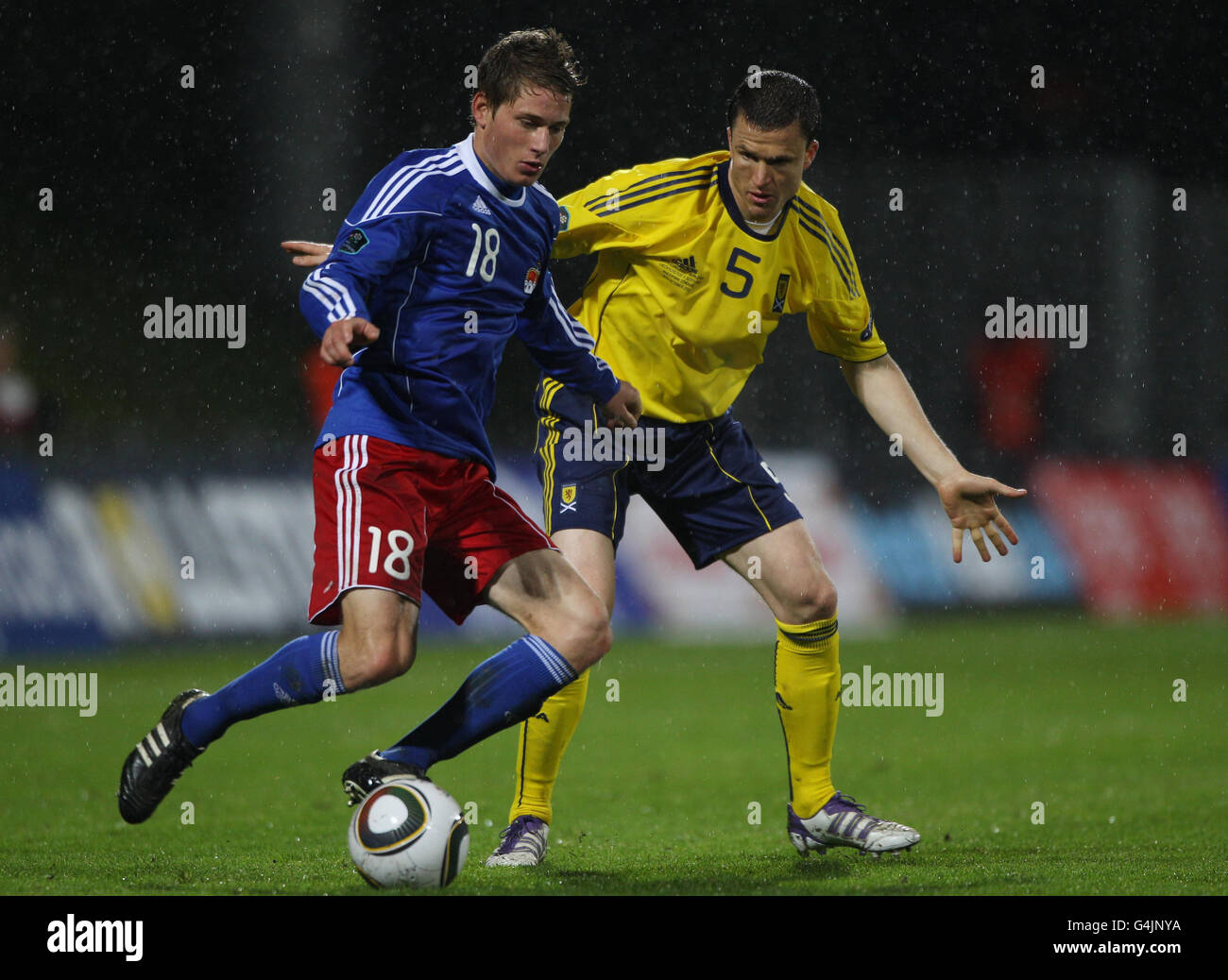 Liechtenstein's Nicolas Hasler (left) tussles with Scotland's Gary ...