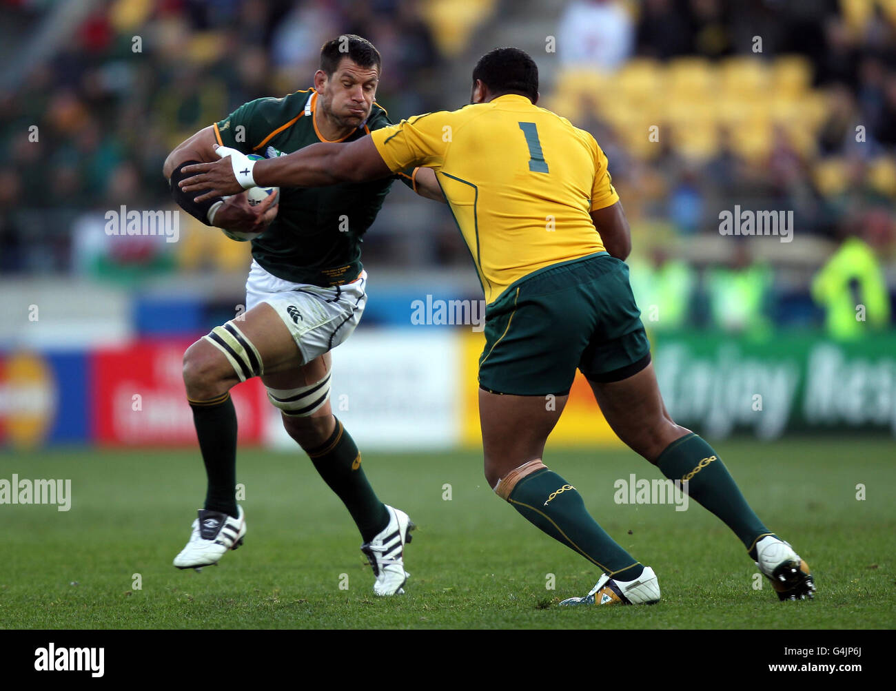 South Africa's Pierre Spies (left) hands off Australia's Sekope Kepu ...