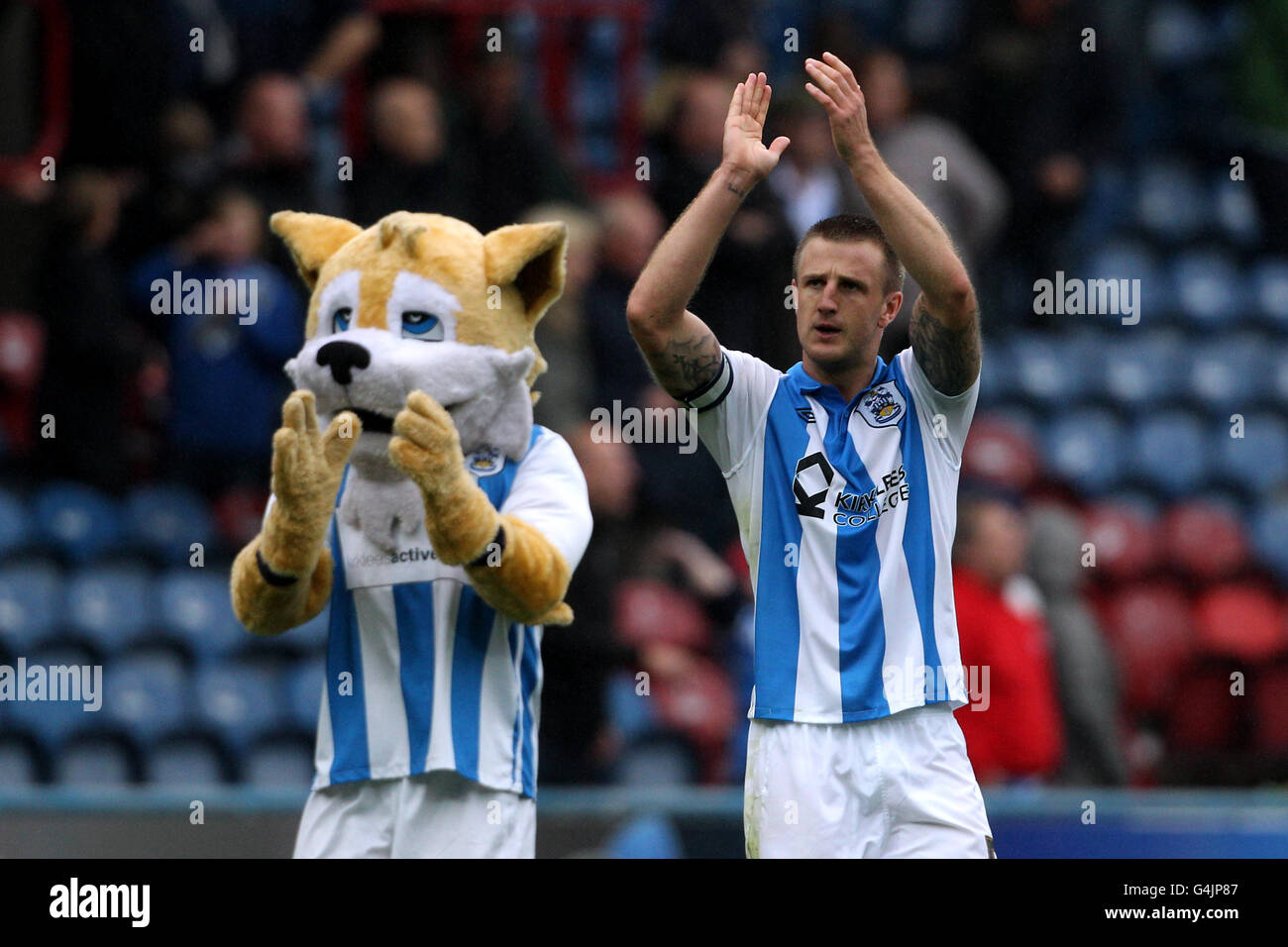 Huddersfield Town's Peter Clarke applauds the fans after the final ...