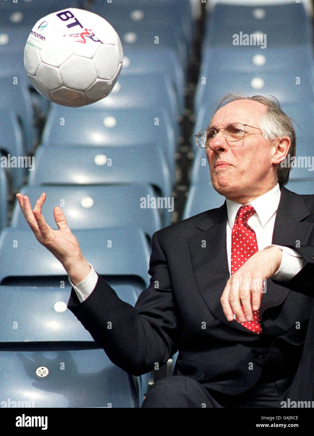 Scottish Secretary Donald Dewar throws a football in the air during a ...