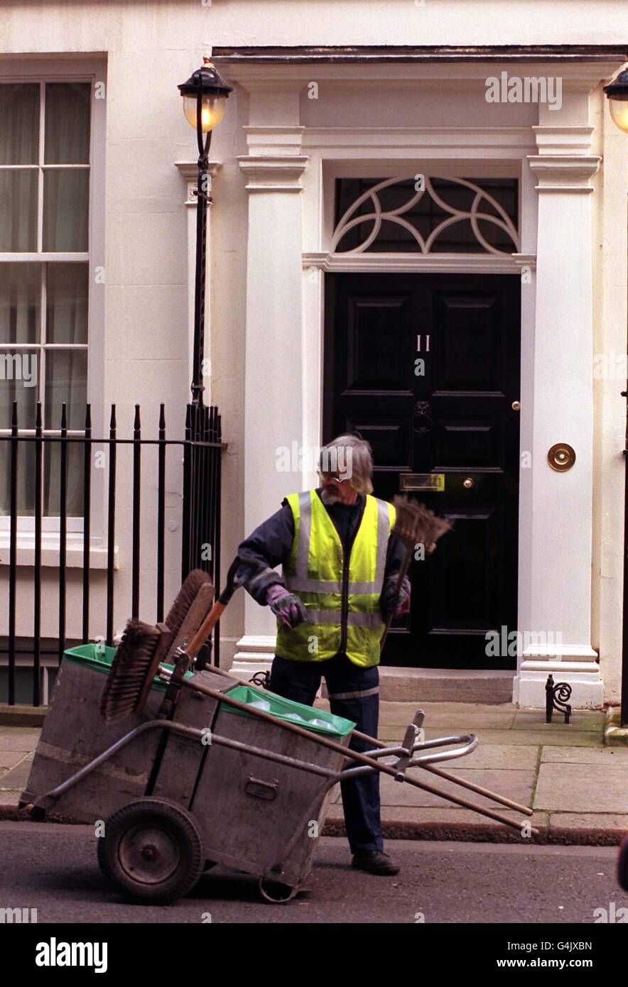 A council cleaner gives the pavement outside 11 Downing Street in ...