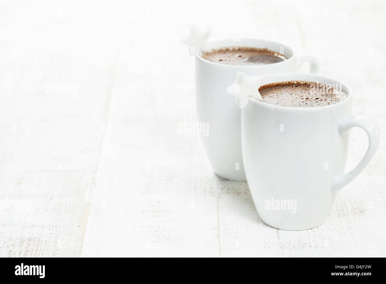 Two coffee cups on white background Stock Photo - Alamy