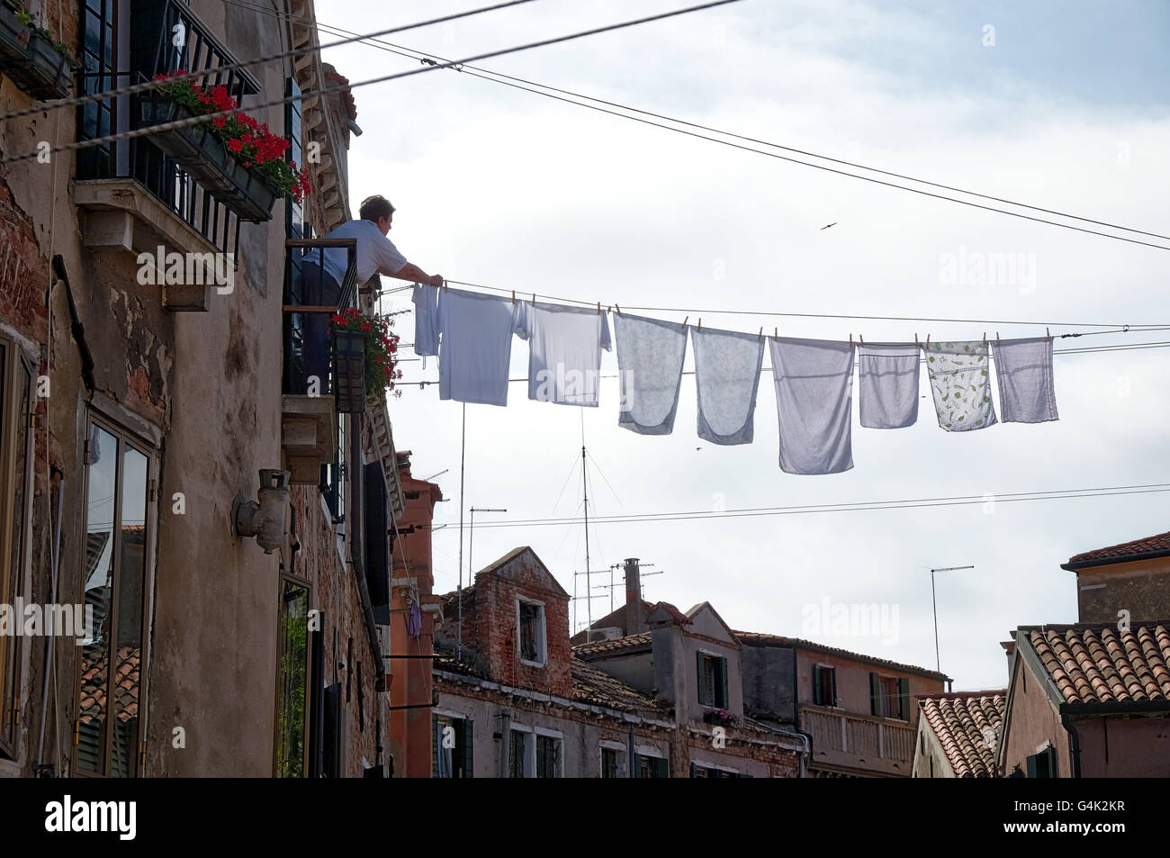 A woman hanging laundry on a clothes line Venice Italy Stock Photo - Alamy