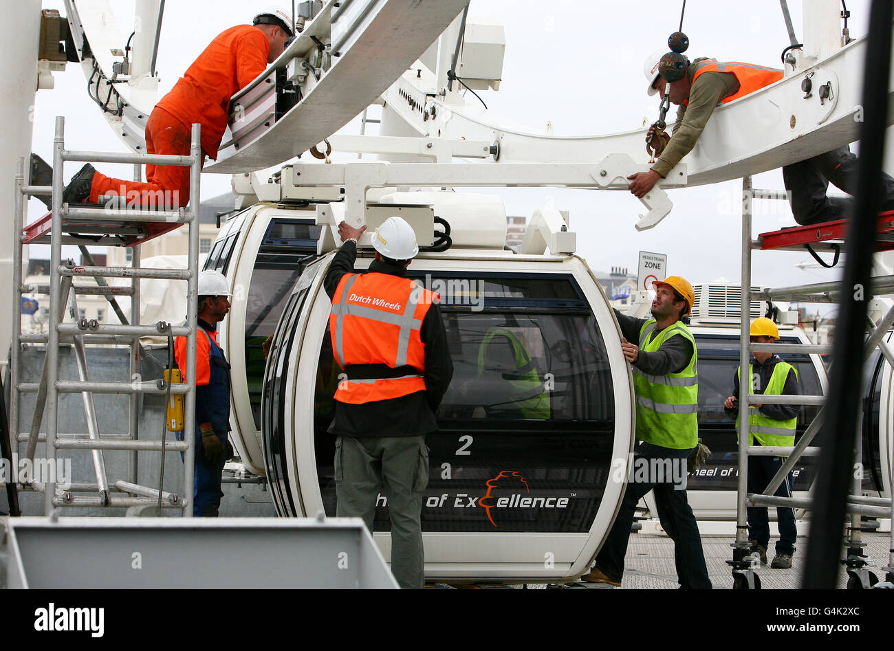 Engineers attach the second passenger pod into position before it is ...