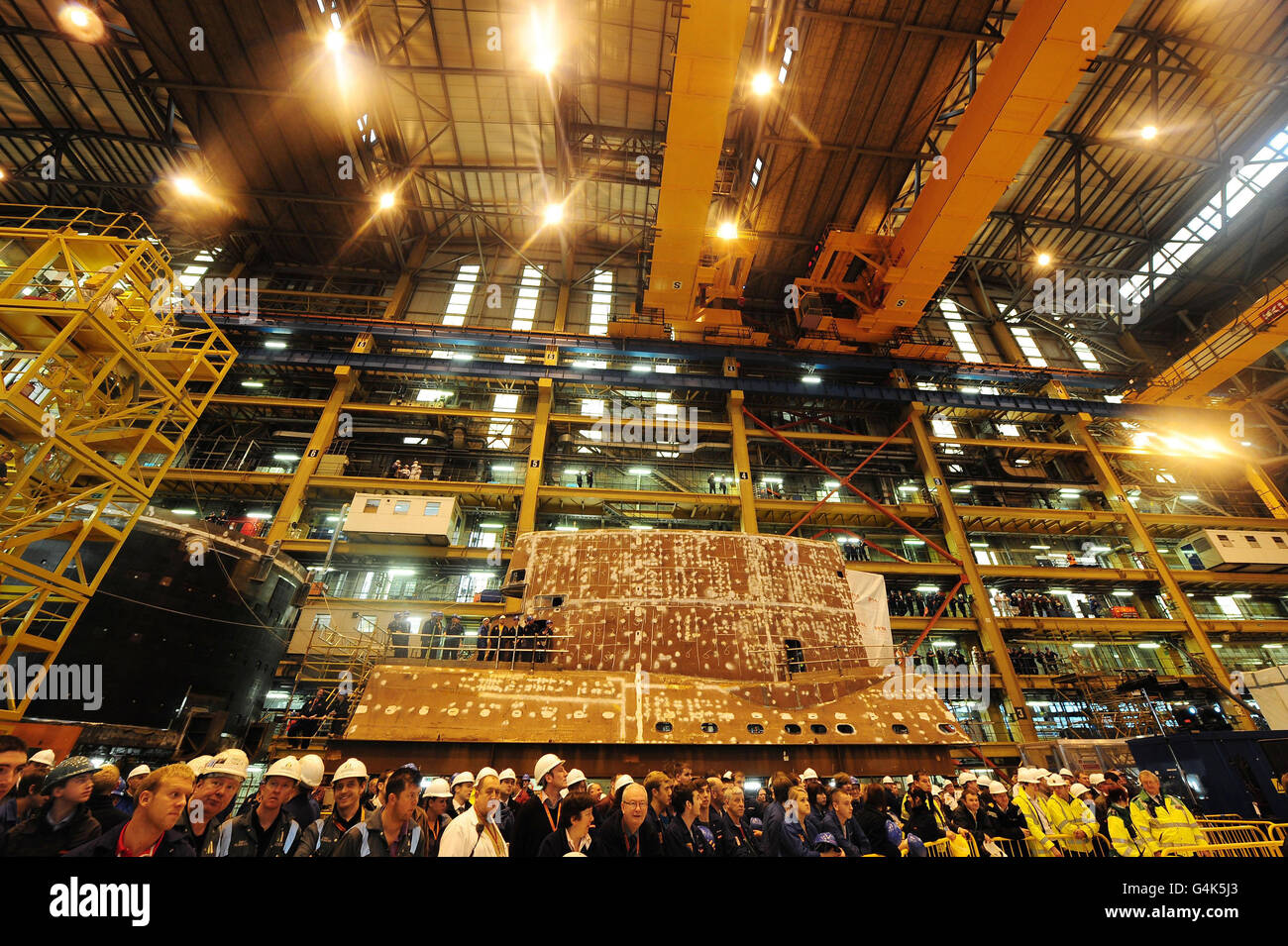 Workers watch from the bridge fin of HMS Audacious during a ceremony to ...