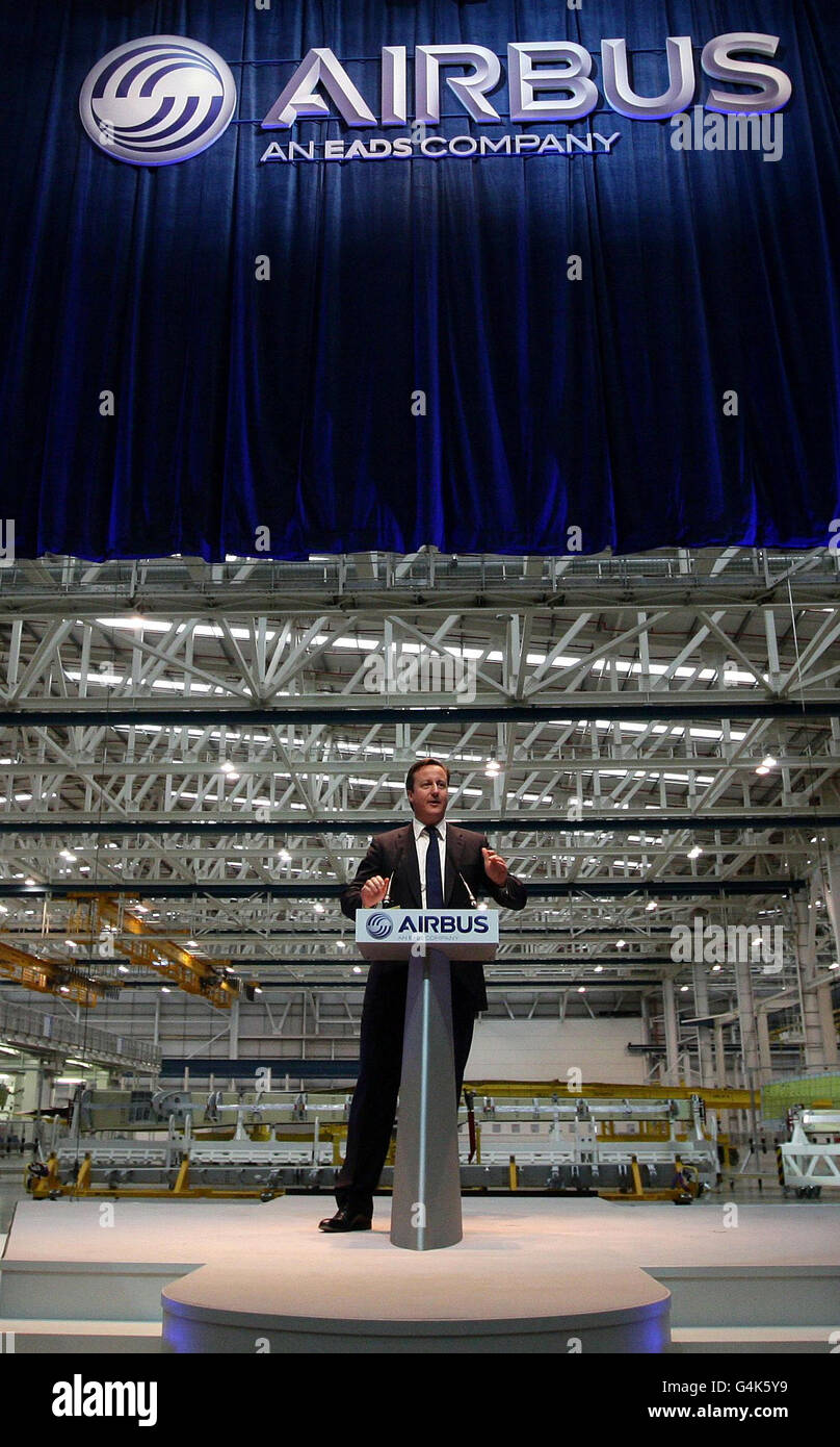 Prime Minister David Cameron talks to staff members during a visit to ...