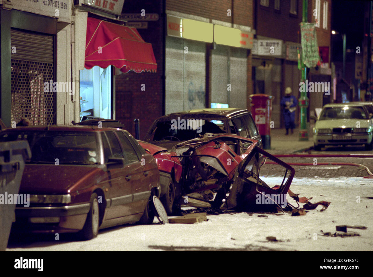 The wreckage of a Ford Sierra lies at the scene of the nail-bomb which ...