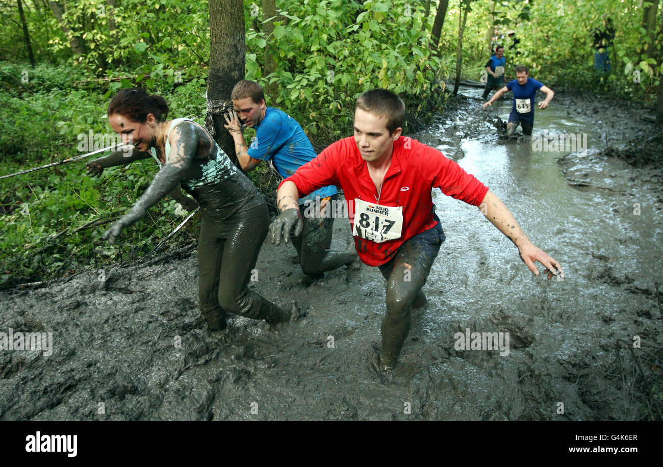 Competitors struggle through the mud on the 7 mile course through the ...