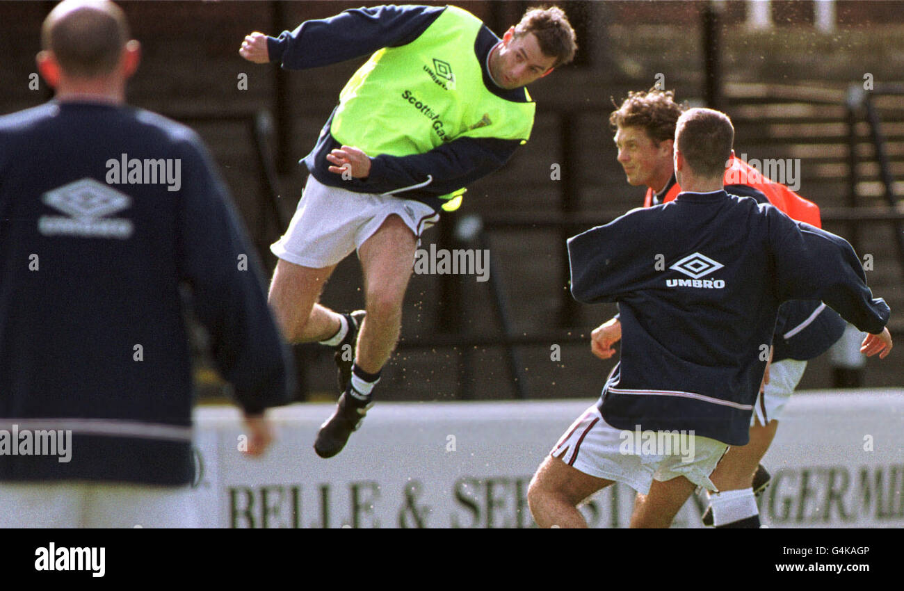 Scotland's Don Hutchison (centre) leaps up to head the ball as Derek ...