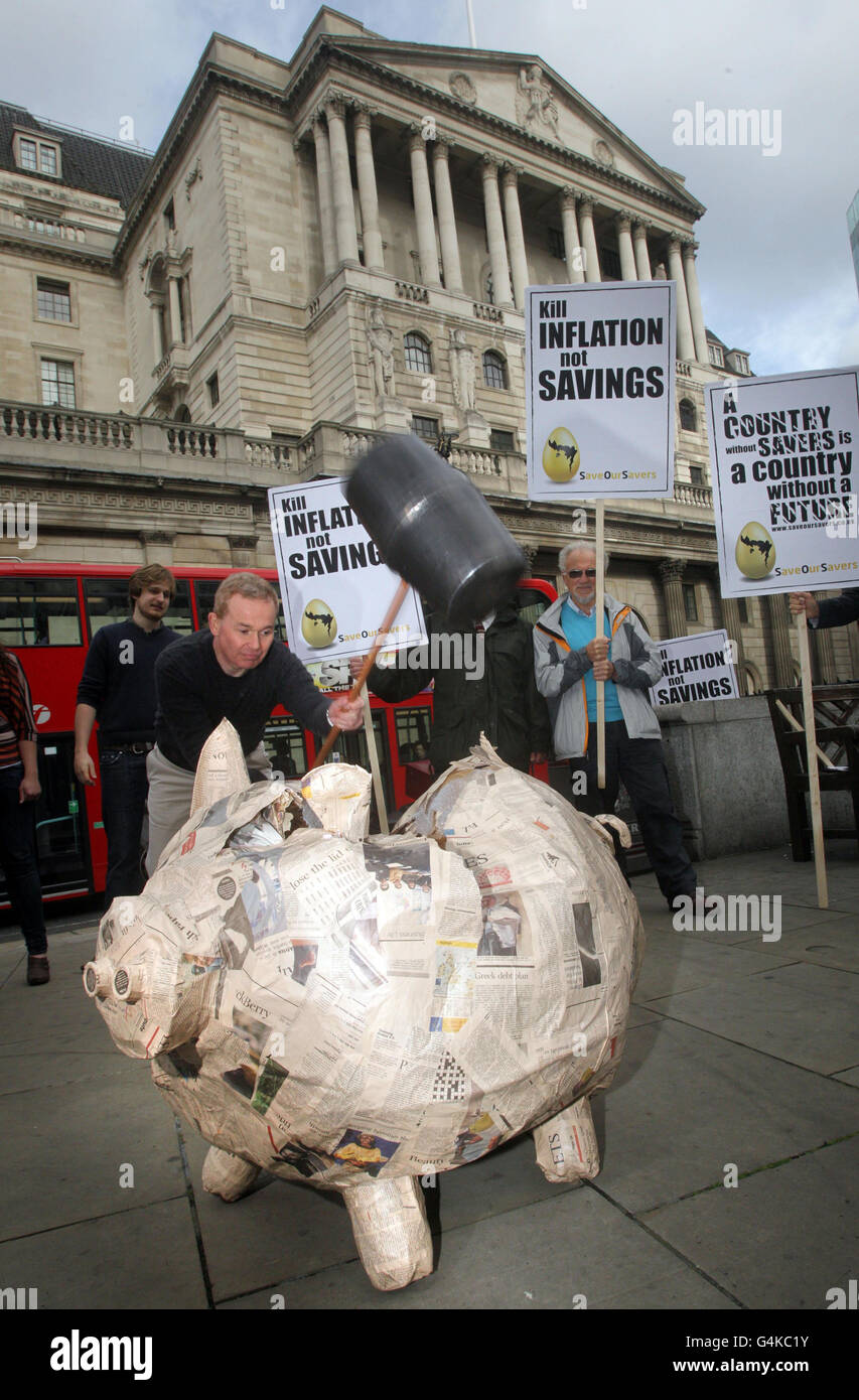 Protesters from Save Our Savers smash a paper piggybank outside the ...