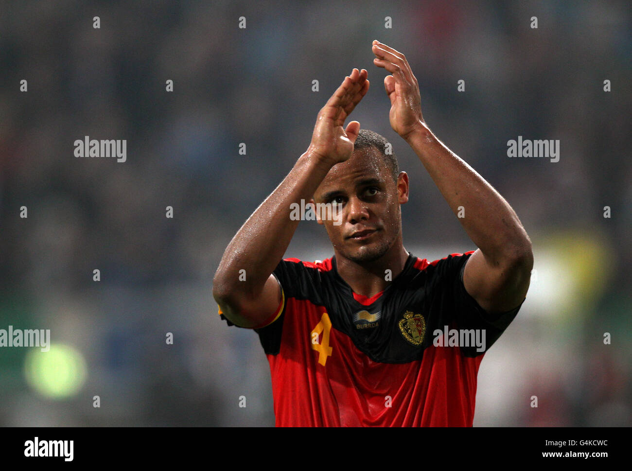 Belgium's captain Vincent Kompany applauds the away fans at the end of ...