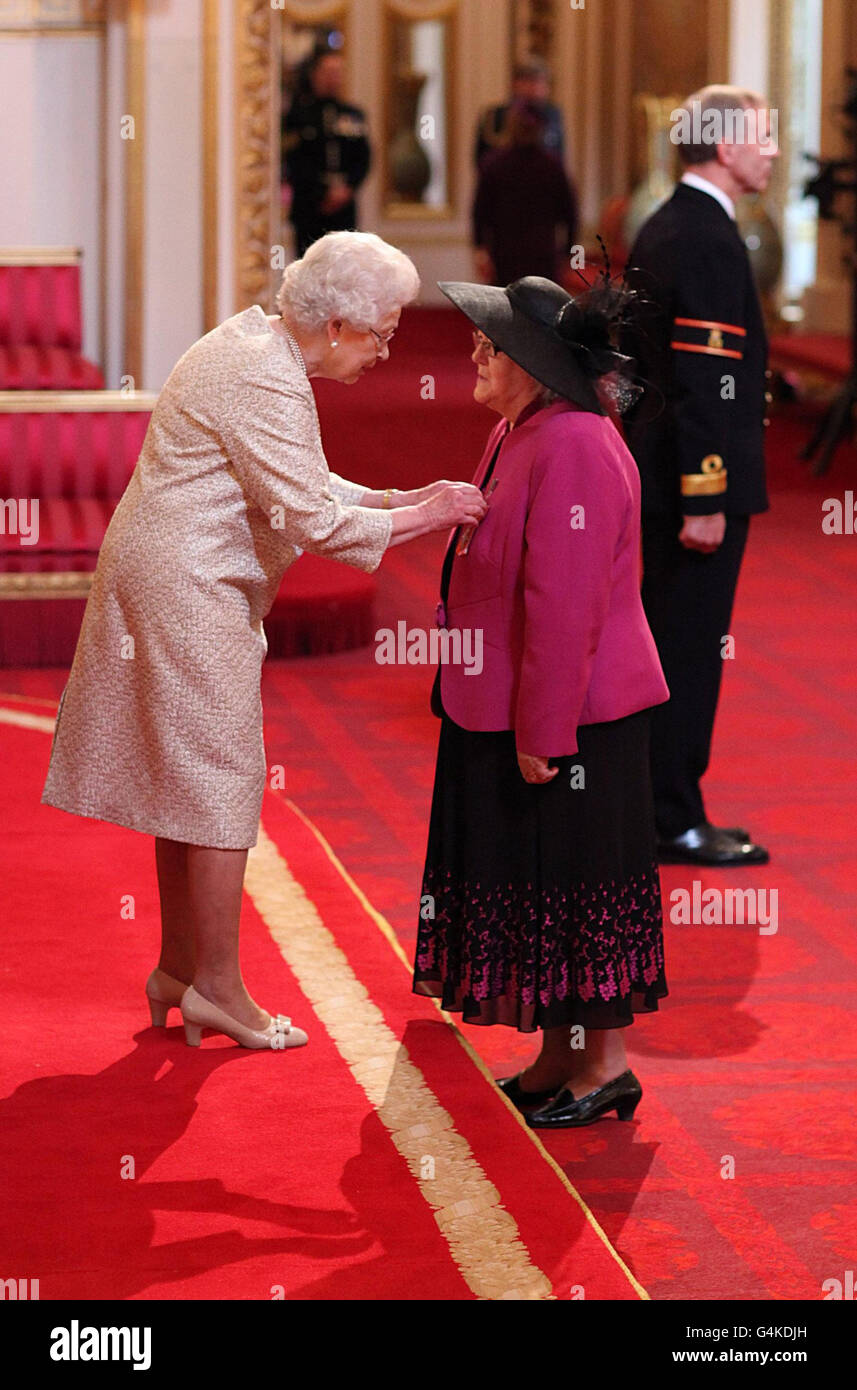 Jean Walker is awarded an MBE by Queen Elizabeth II during an ...