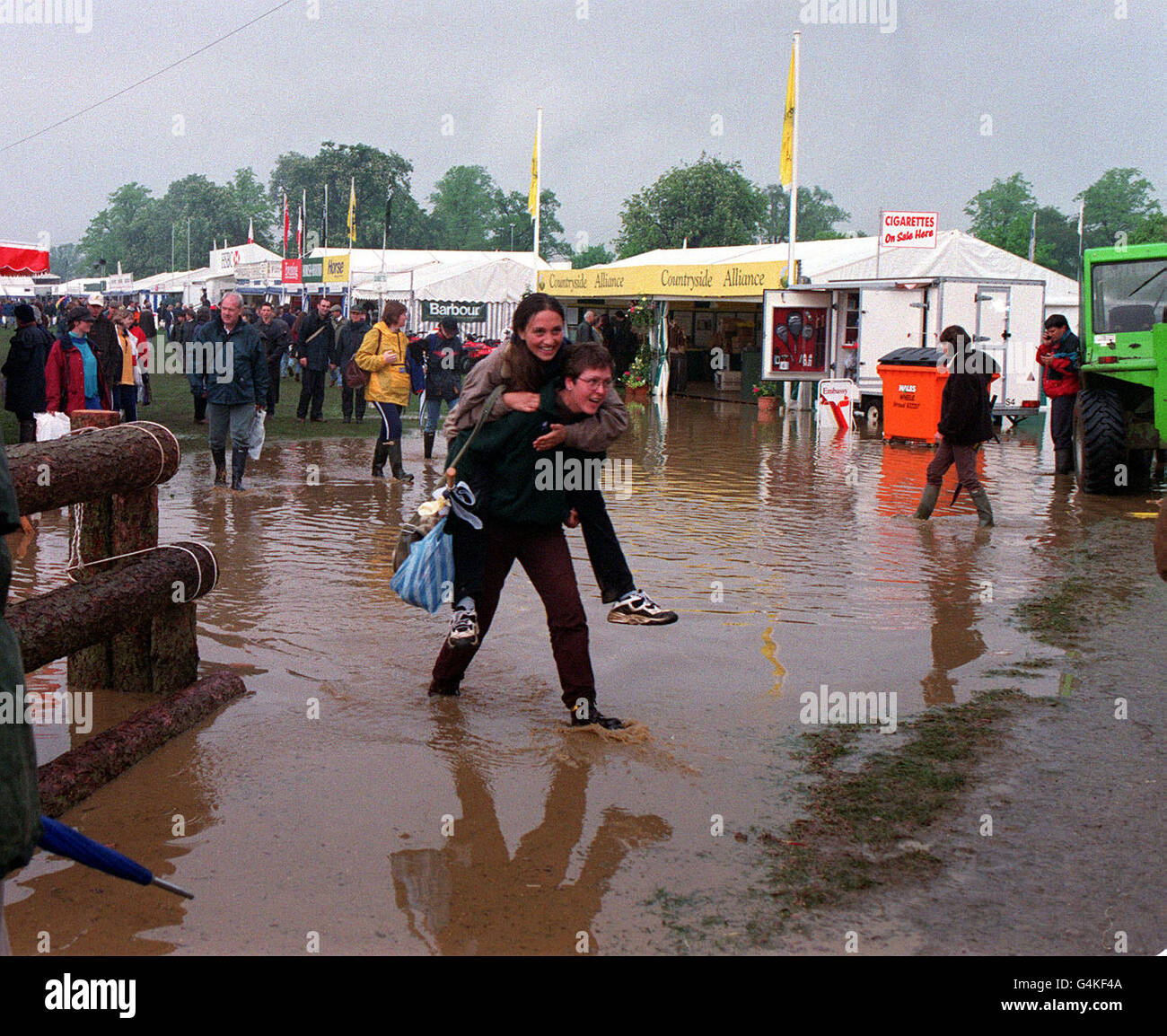 Spectators wade through puddles at Badminton, where the Horse Trials ...