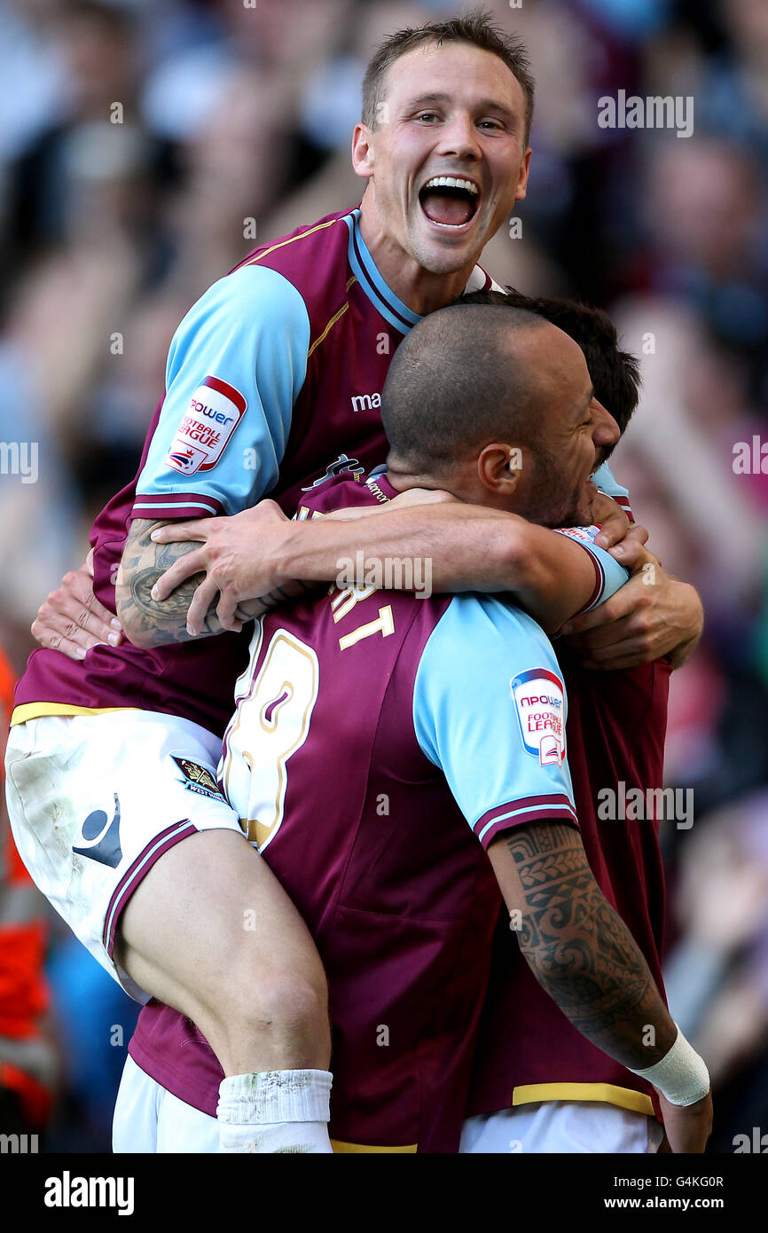 West Ham United's Sam Baldock (hidden) is mobbed by teammates Matt ...