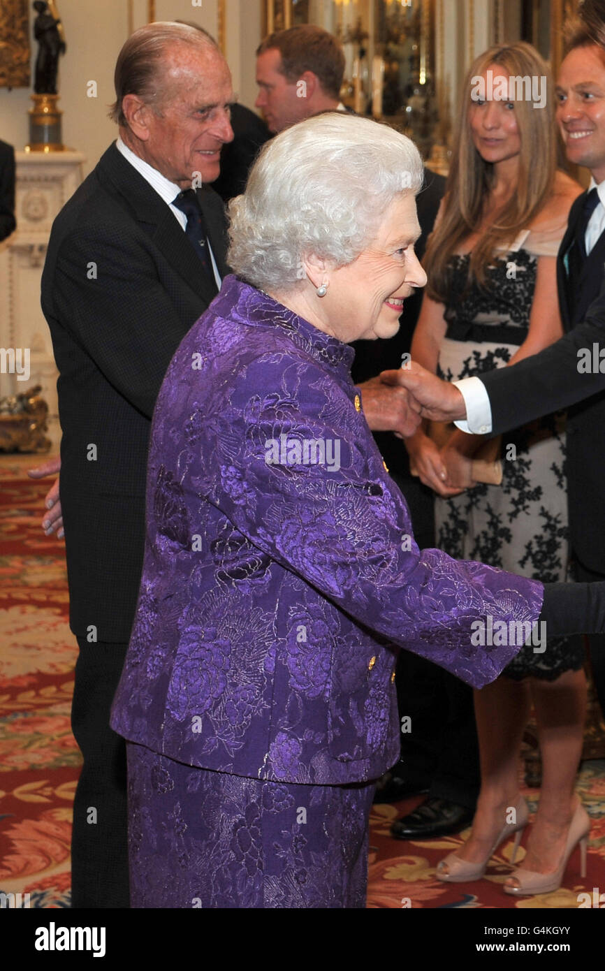 Fashion designer Collette Dinnigan (back right) looks on as Queen ...