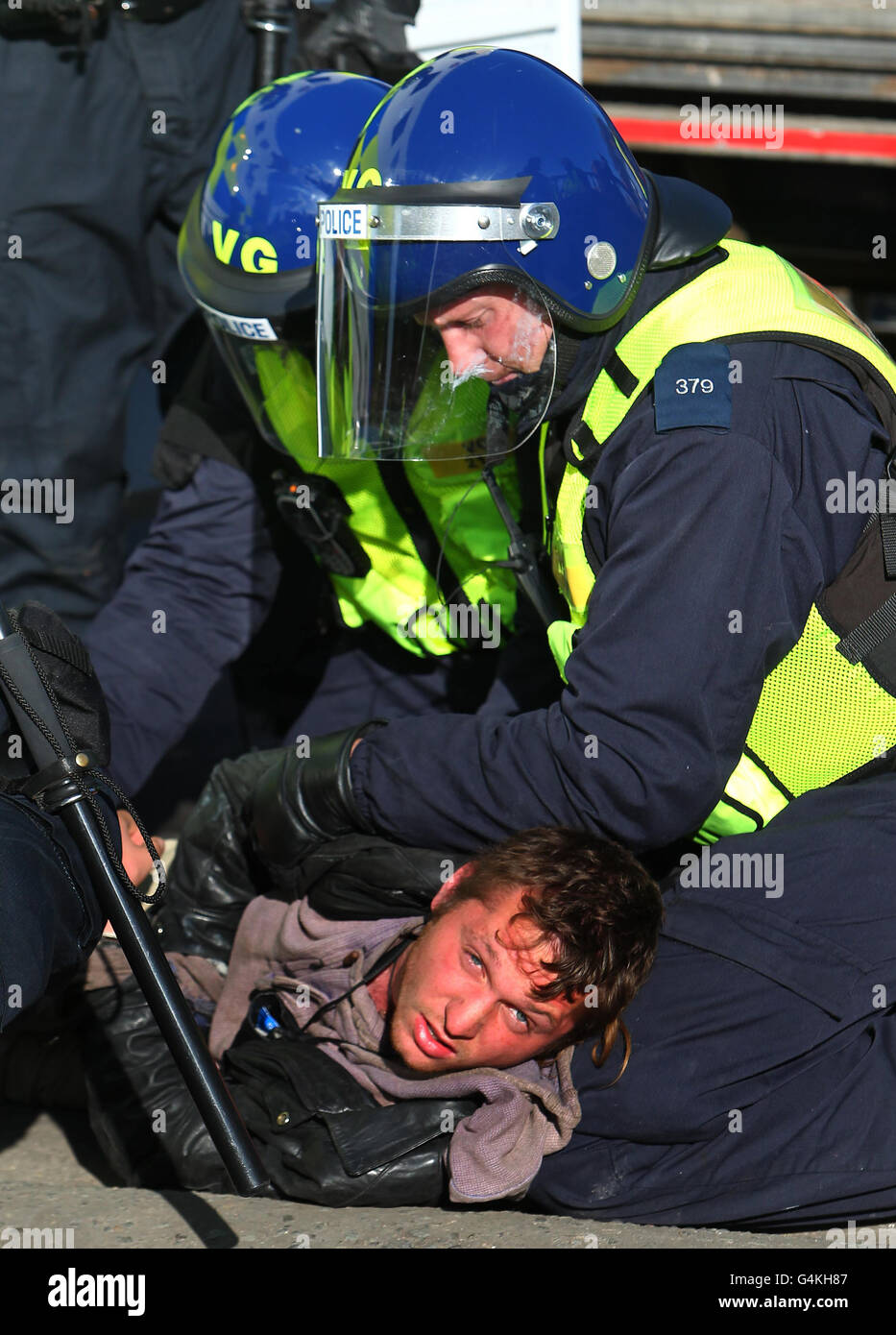 Police officers detain an activist, at Dale Farm in Essex where ...