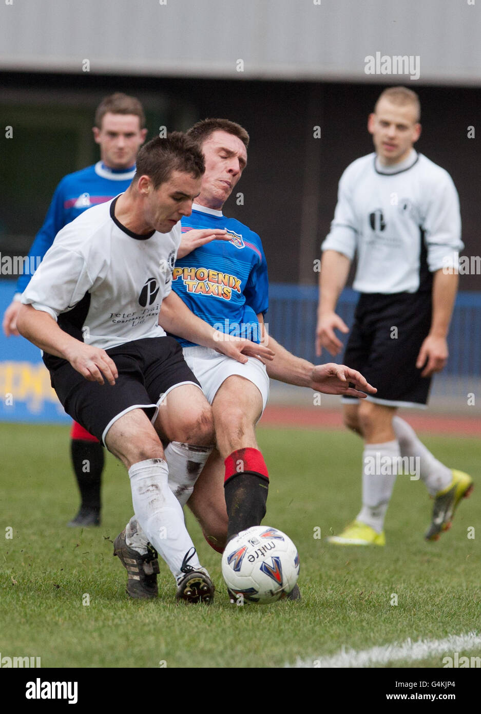Edinburgh City's Ian McFarland tackles Irvine Meadow's David Hamilton ...