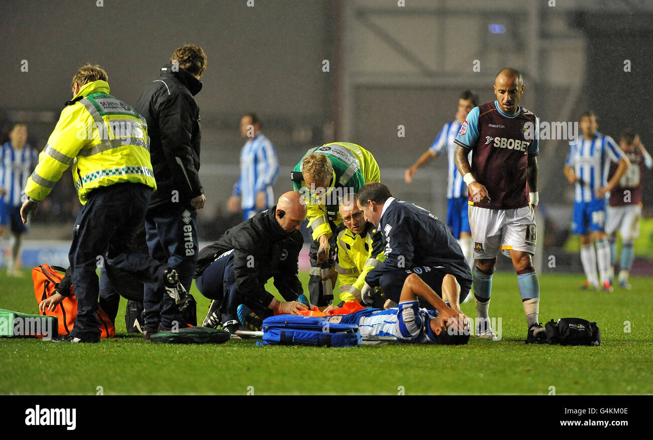Brighton and Hove Albion's Gary Dicker is attended to by medical staff ...