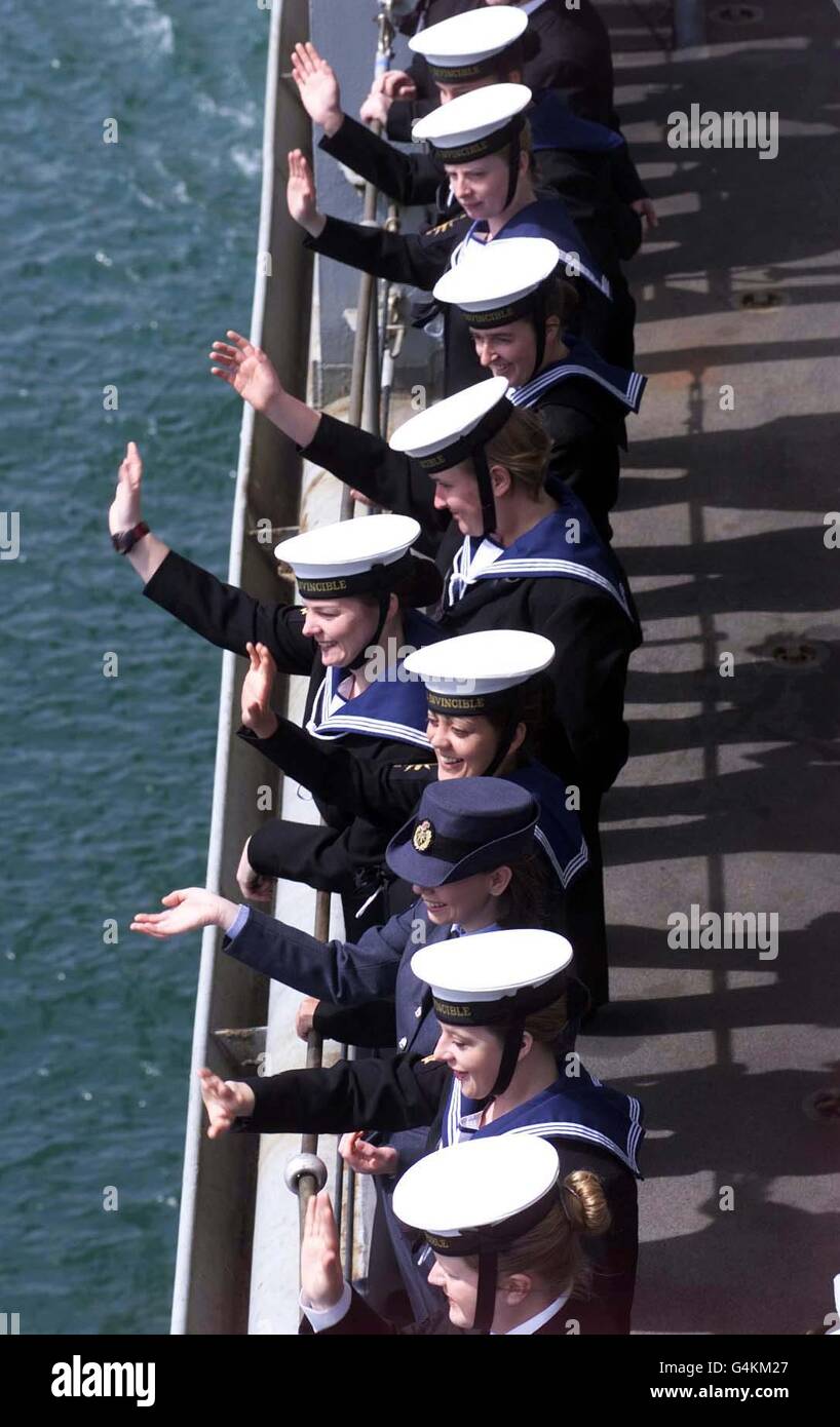 Members of the crew of the HMS Invincible wave to their families as ...