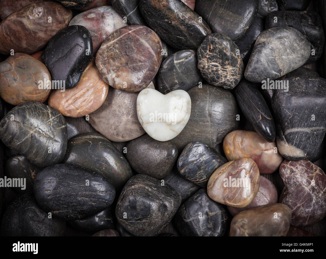 Stones with heart shaped white stones as background Stock Photo - Alamy