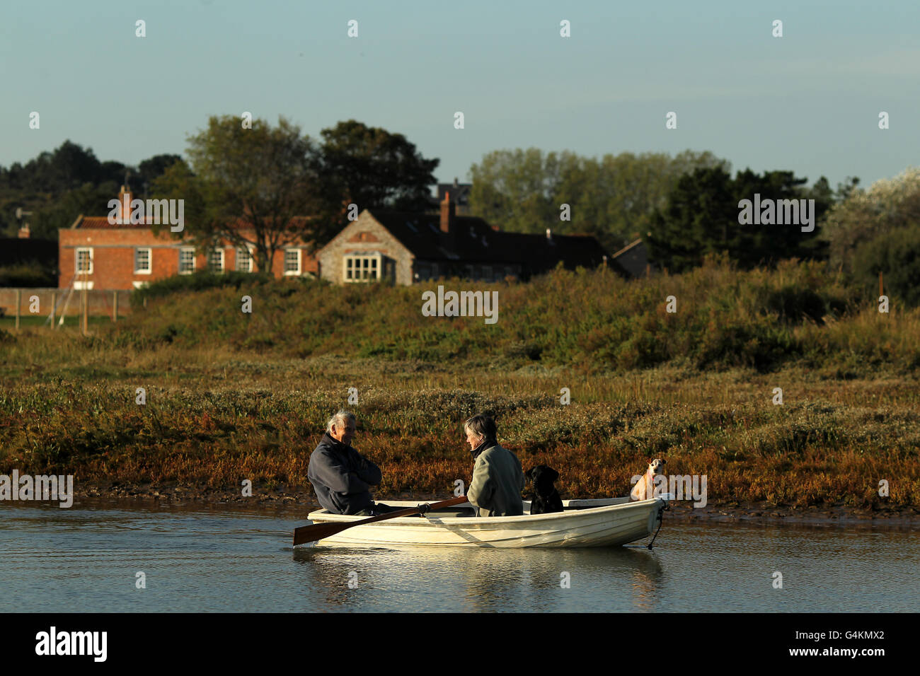 People enjoy a trip in a rowing boat with their dog from the small ...