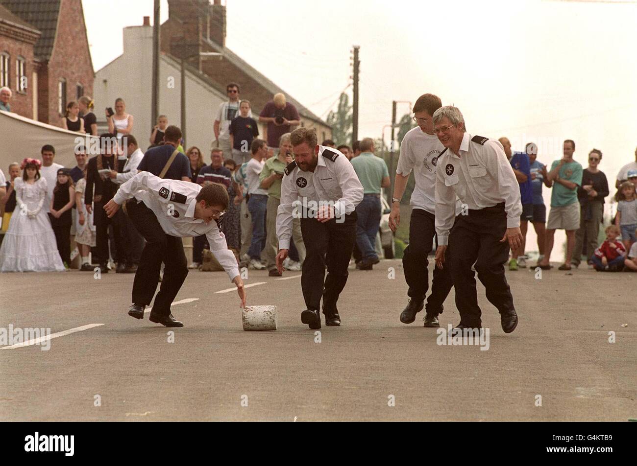 Participants take part in the traditional May Day "Stilton cheese ...