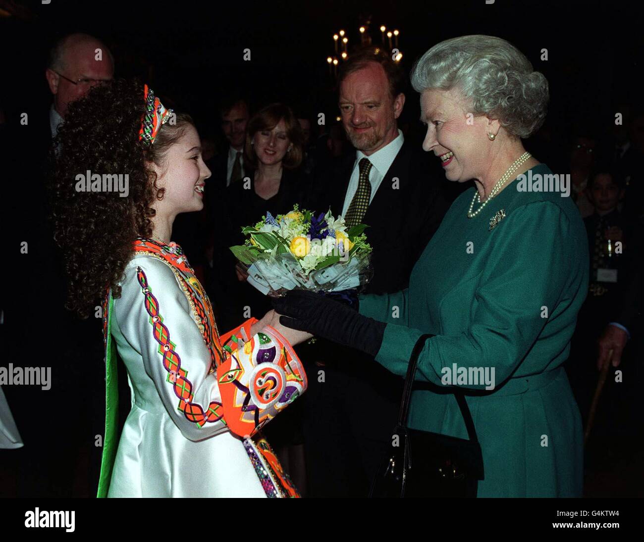 Britain's Queen Elizabeth II, watched by Forign Secretary Robin Cook ...