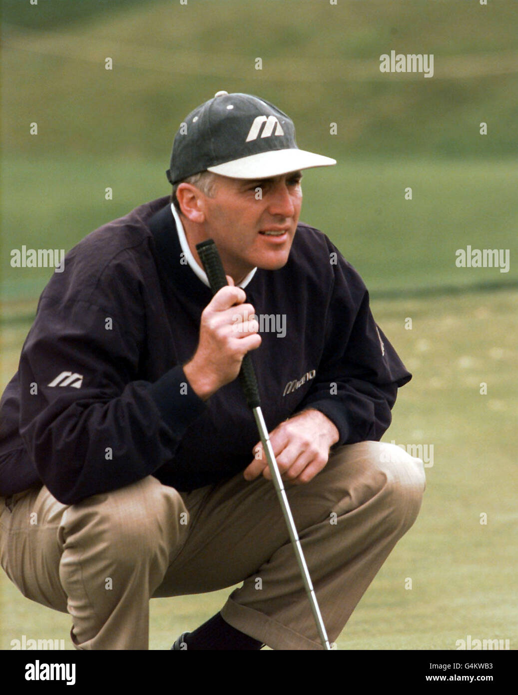 Phil Price of Wales lines up his putt on the first green during the ...