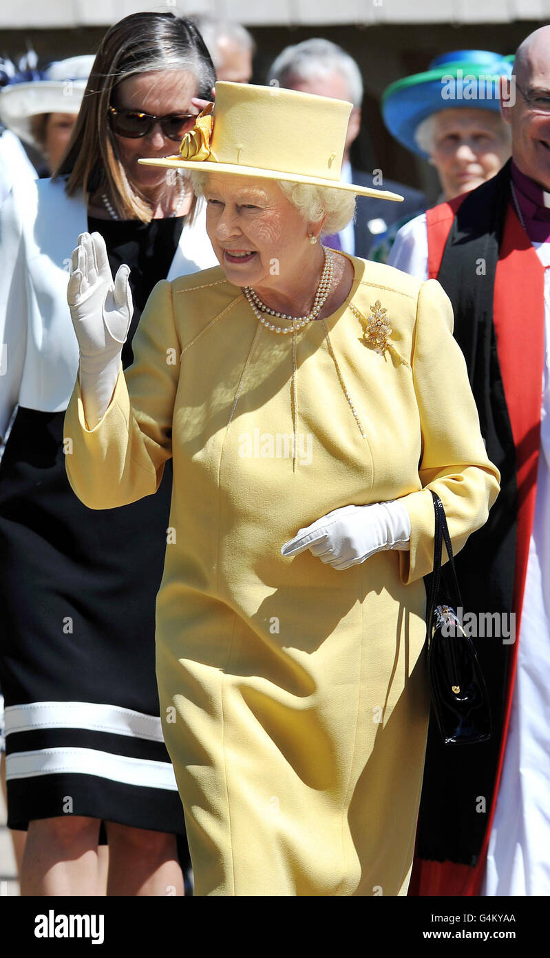 The Queen waves to well wishers as she arrives with the Duke of ...
