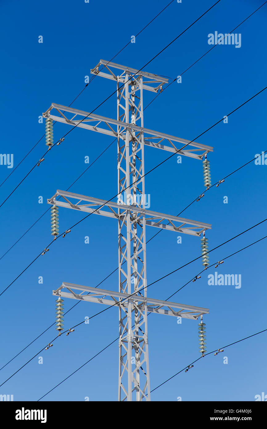Electric power lines on a blue sky background Stock Photo - Alamy