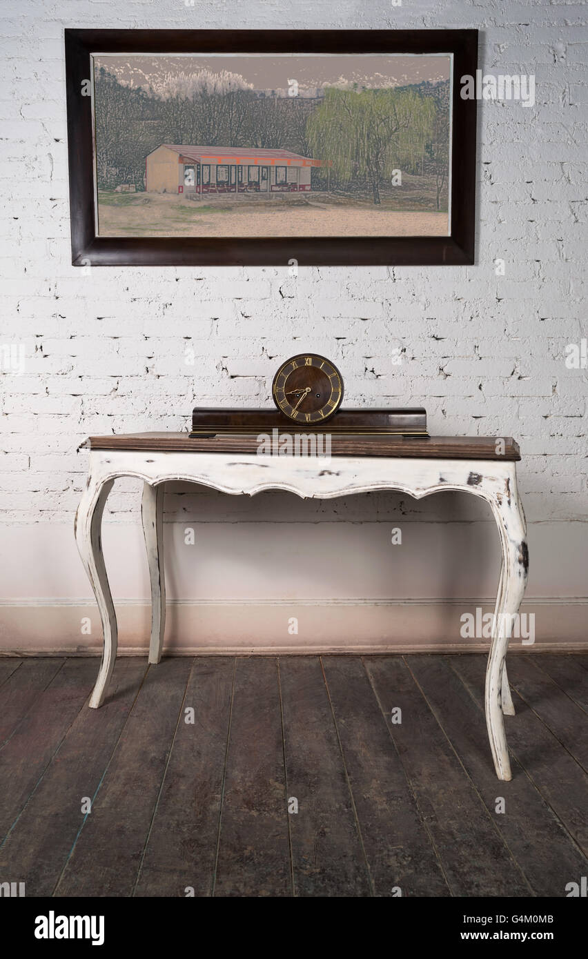 Old retro desktop clock placed on white vintage wooden table Stock ...