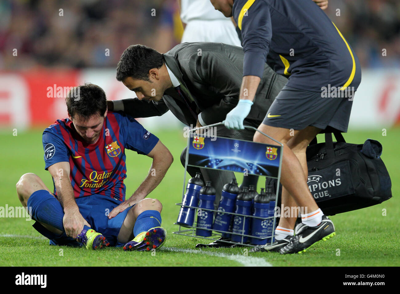 Barcelona's Lionel Messi (left) receives treatment for an injury Stock ...