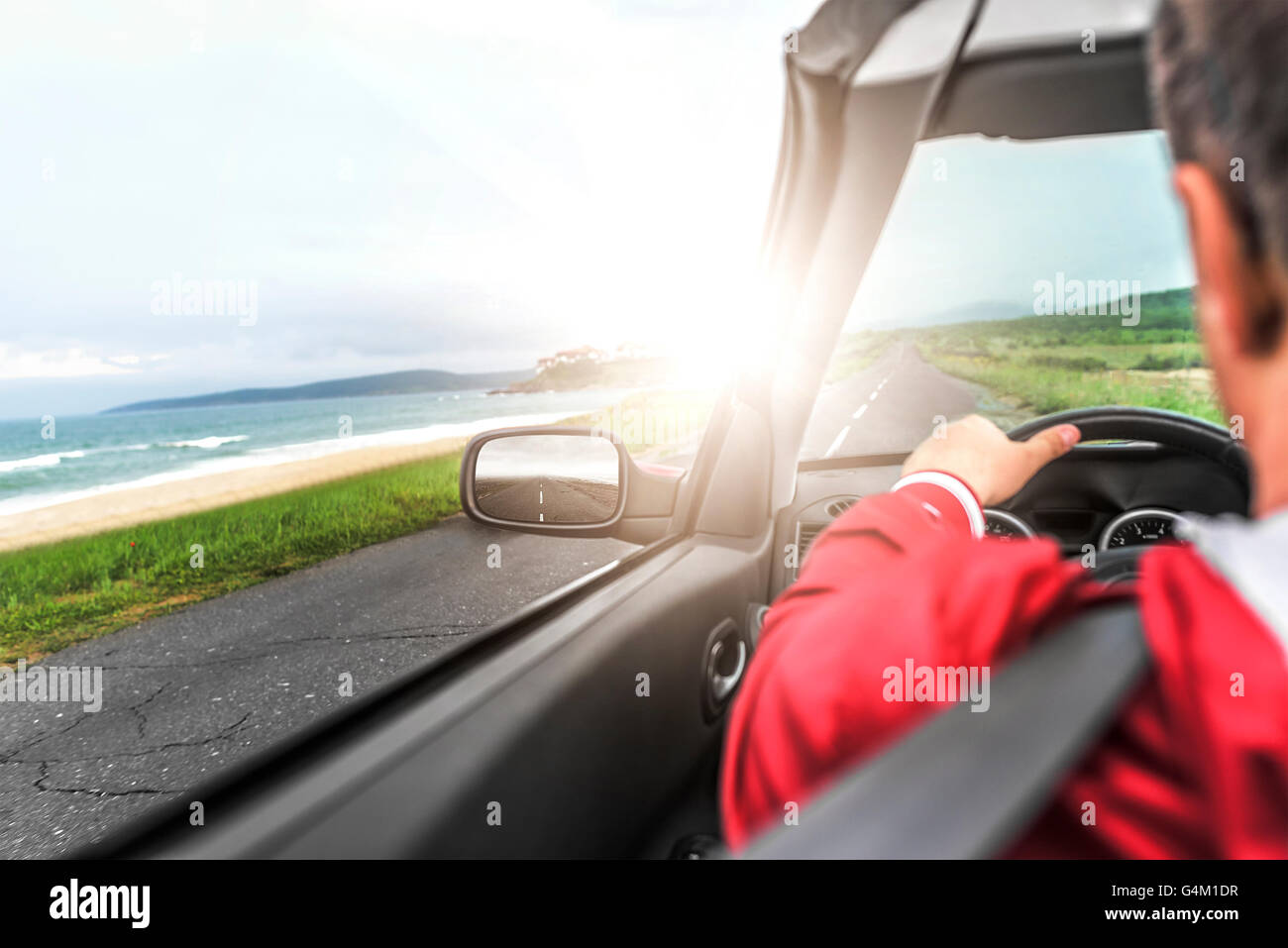 Red car driving on a rural road hi-res stock photography and images - Alamy