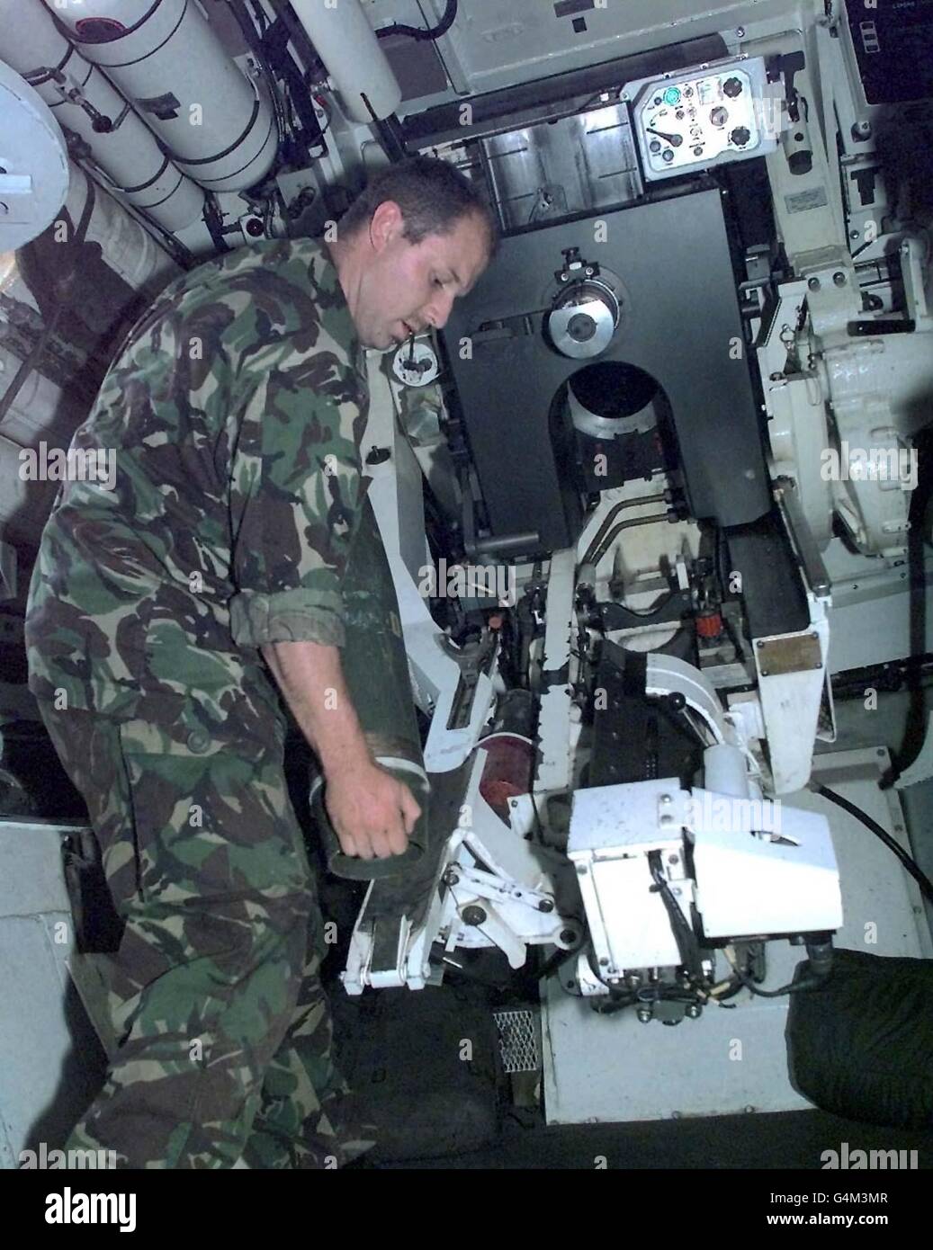 Sgt. Trevor Childerley from Nottingham loads a shell in to an SA90 on ...