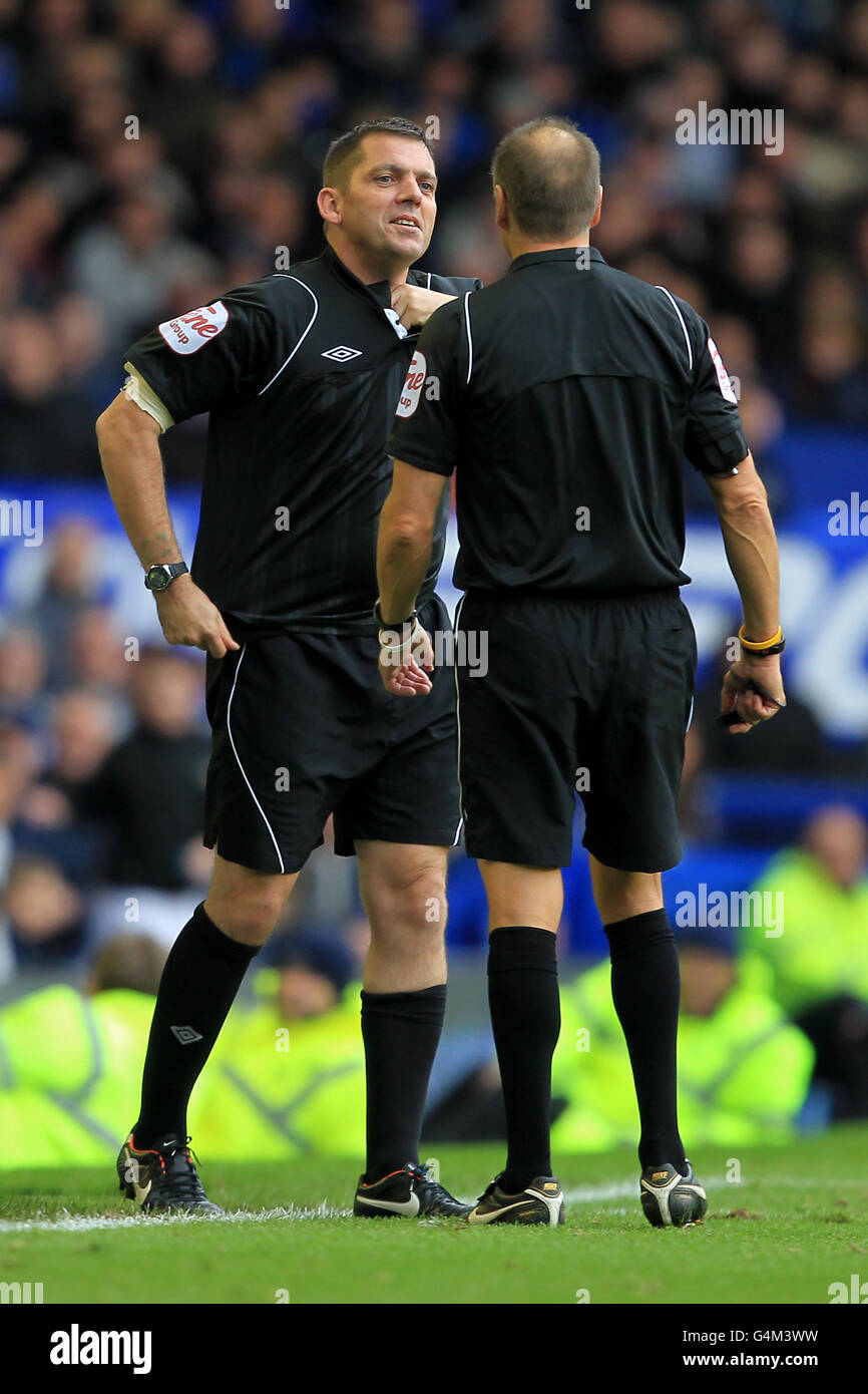 Fourth Official Phil Dowd (left) chats to referee Mark Halsey as he ...