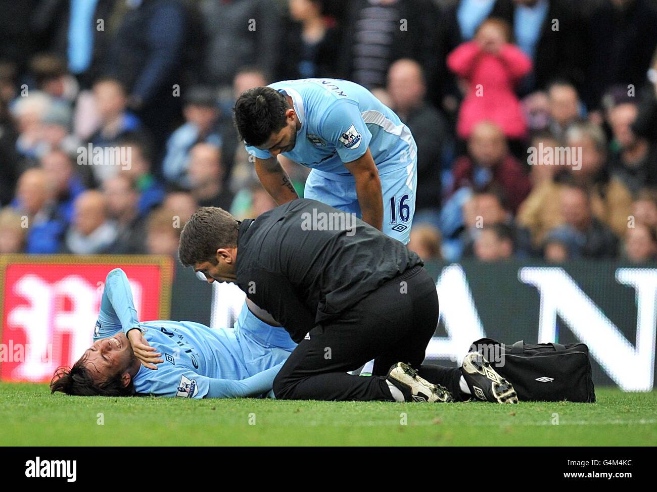 Manchester citys david silva receives treatment from a physio hi-res ...