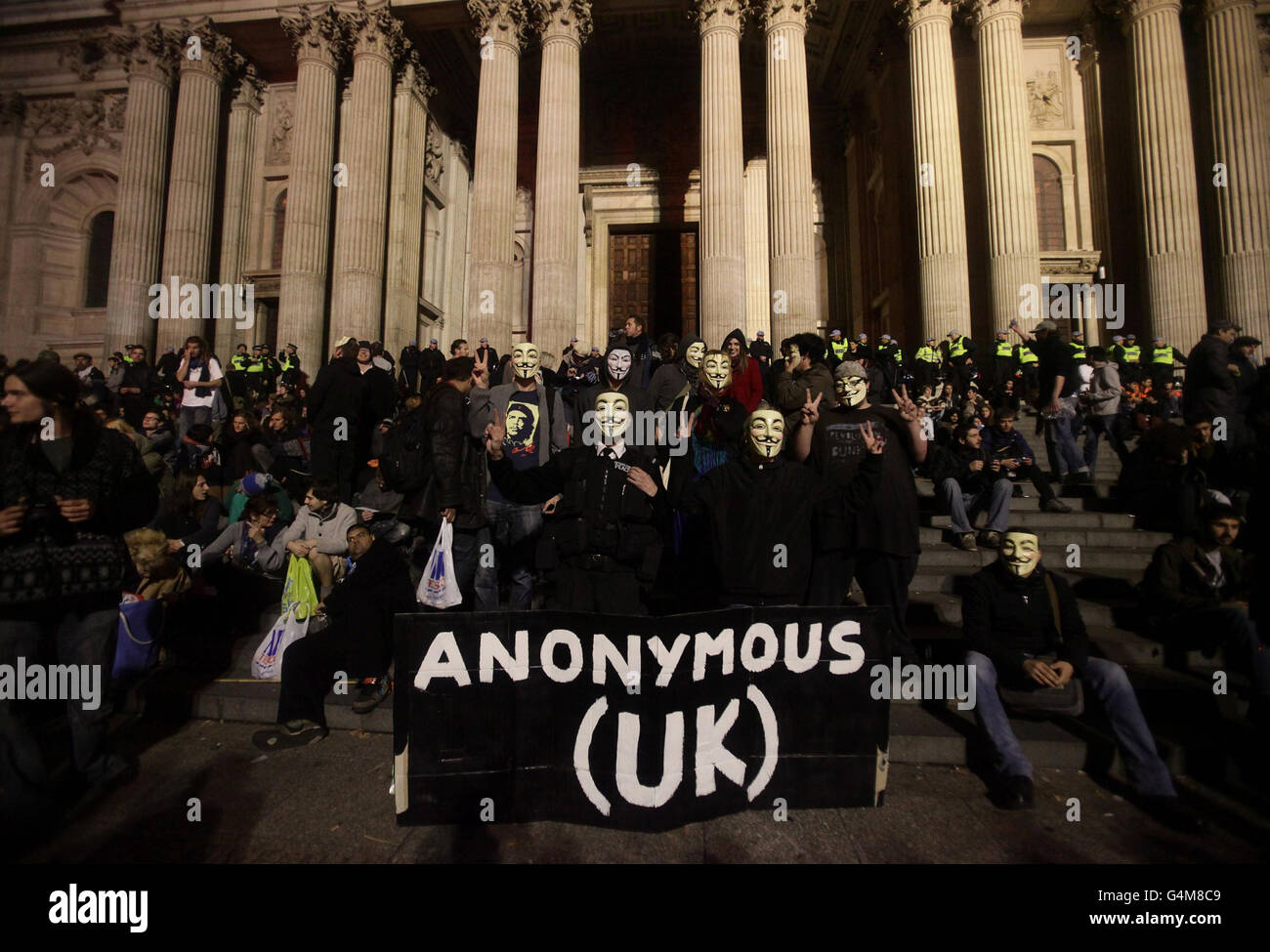 Protesters carrying an Anonymous UK banner outside St Paul's Cathedral ...