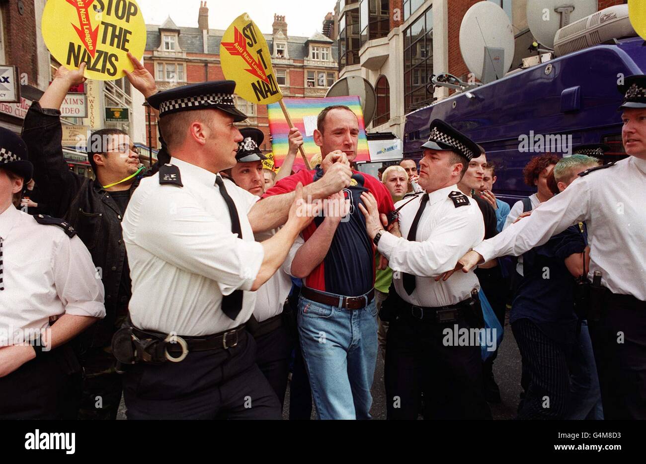 Police restrain an over enthusiastic protester, during a march through ...