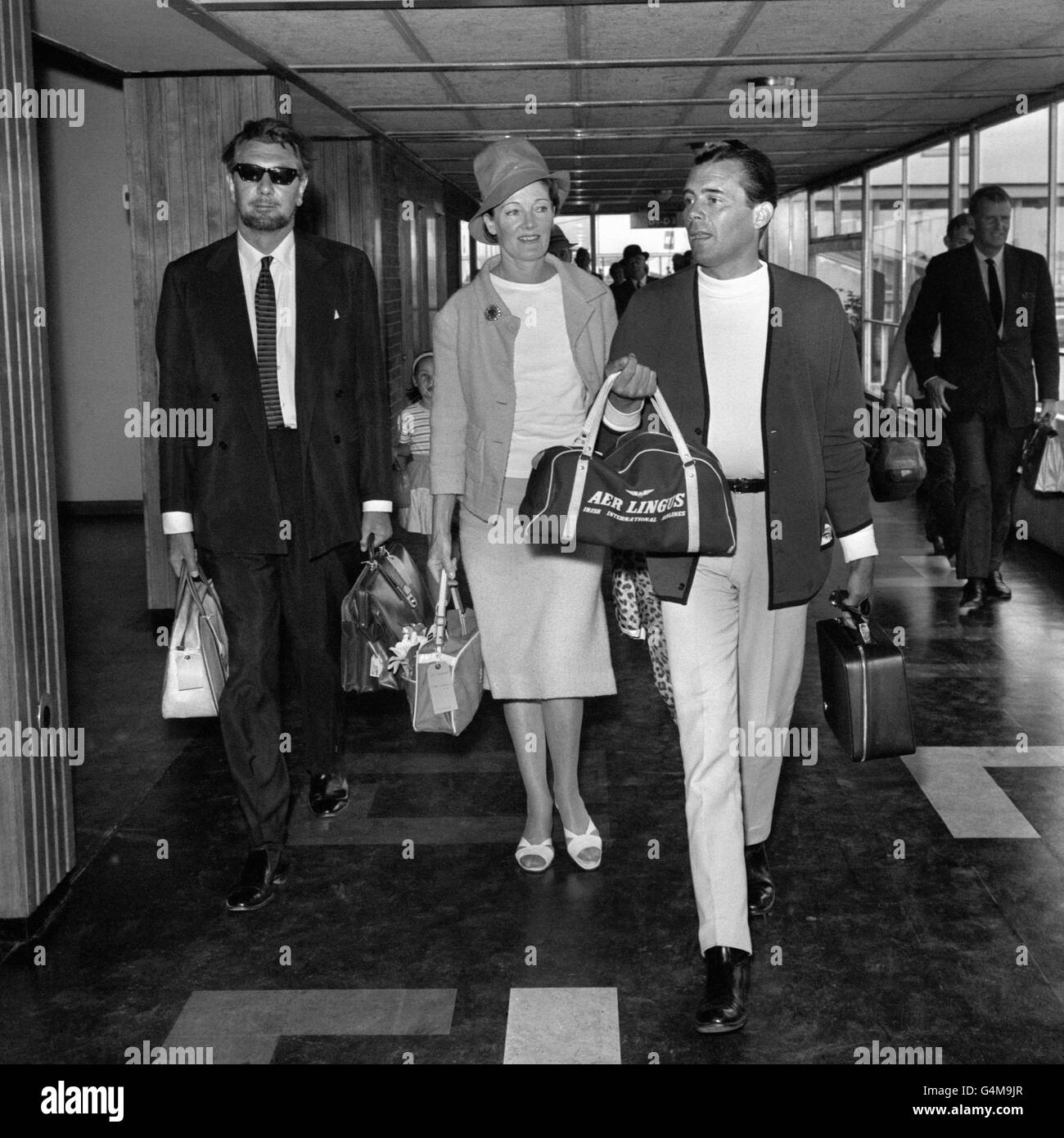 British film star Dirk Bogarde (right) at London Airport with fellow ...