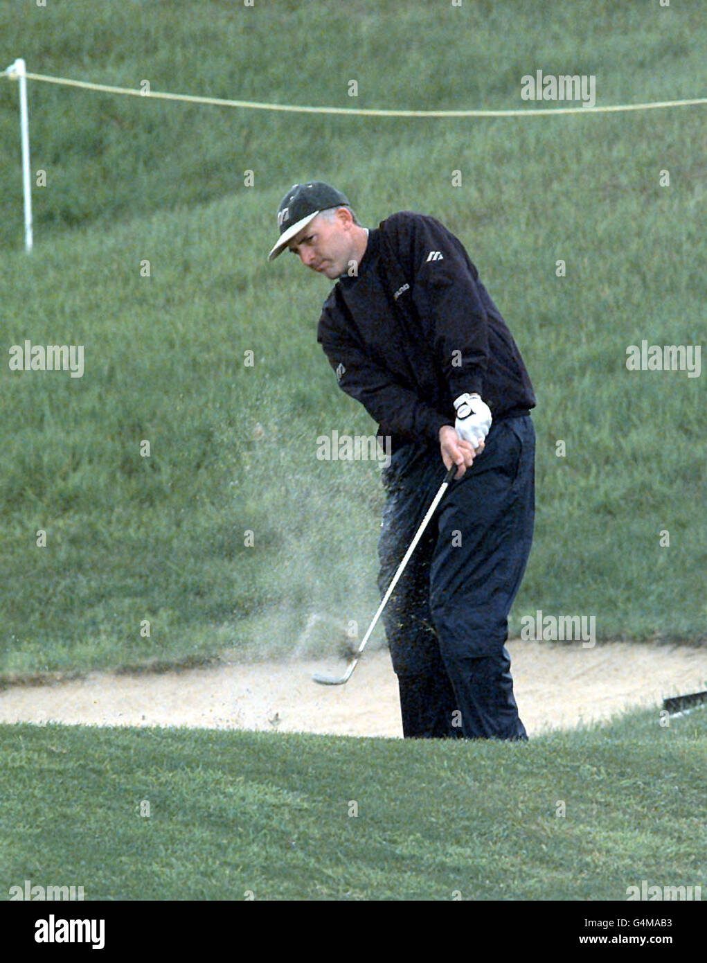 Phil Price from Wales plays out of a bunker on the 7th, during his ...