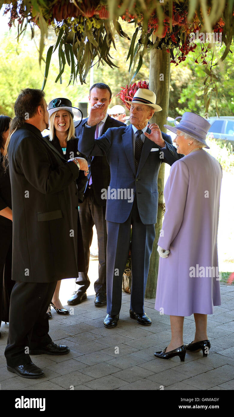 Queen Elizabeth smiles as the Duke of Edinburgh asks a gardener how he ...