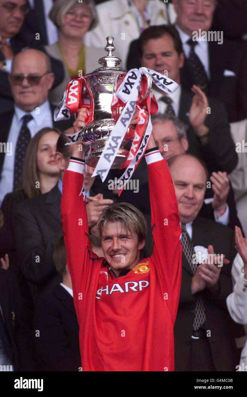 Manchester United's David Beckham celebrates with the trophy following ...