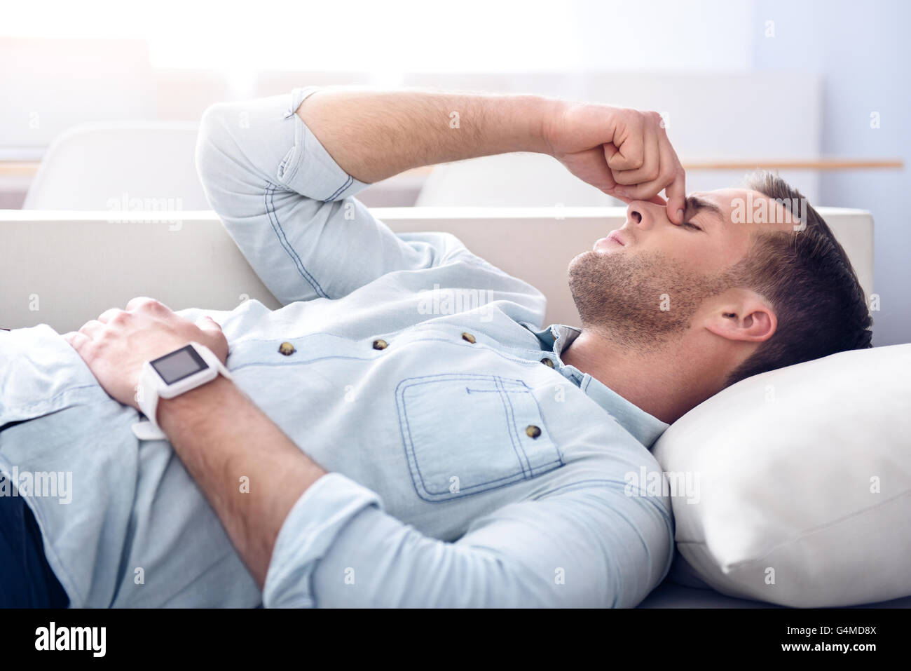 Sick unhealthy man lying on the couch Stock Photo - Alamy
