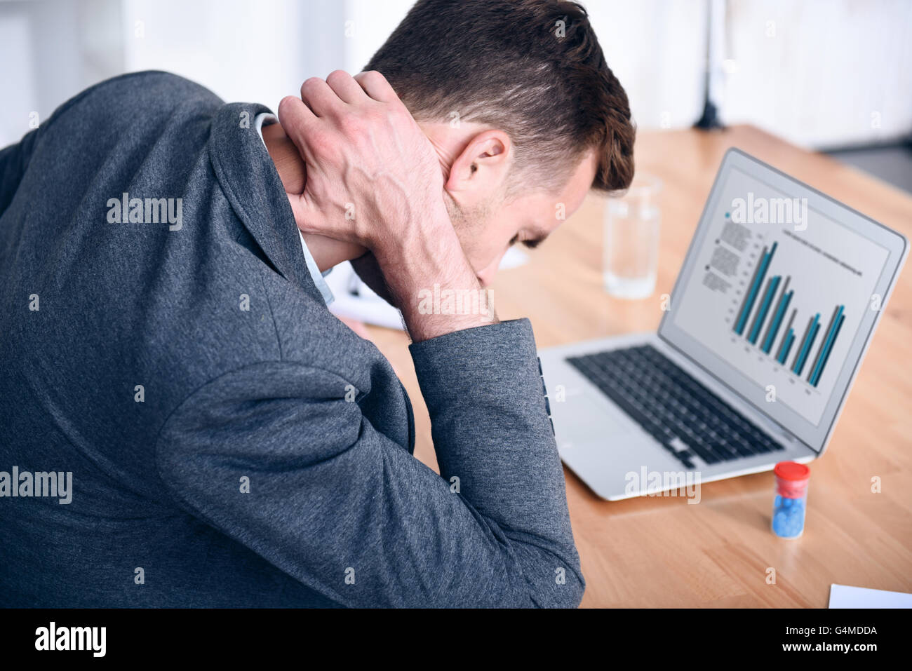 Sick man sitting at the table Stock Photo - Alamy