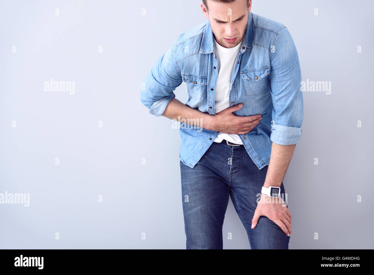 Cheerless man standing isolated on white background Stock Photo - Alamy
