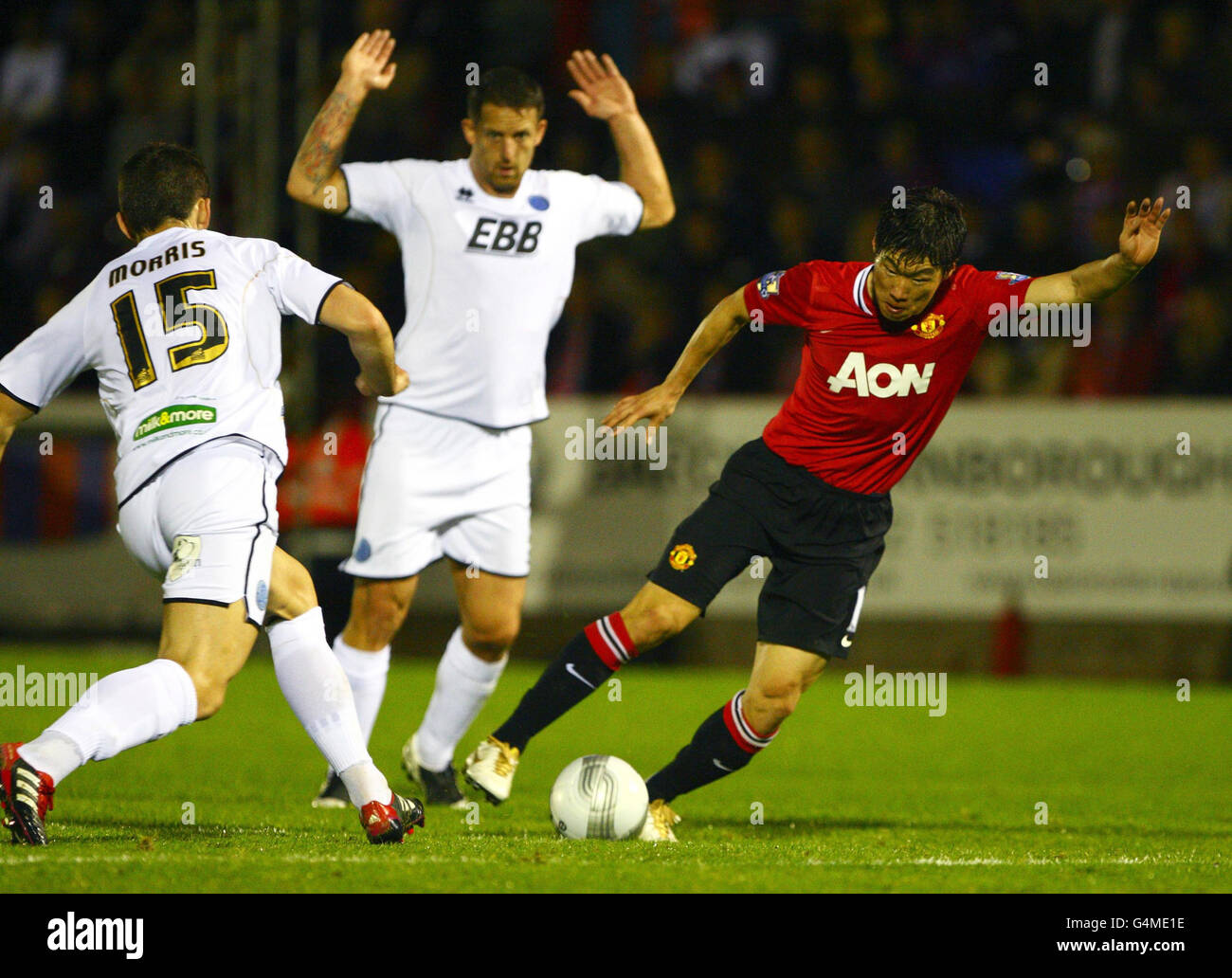 Aldershot's Aaron Morris (left) and Manchester's Ji-Sung Park battle ...