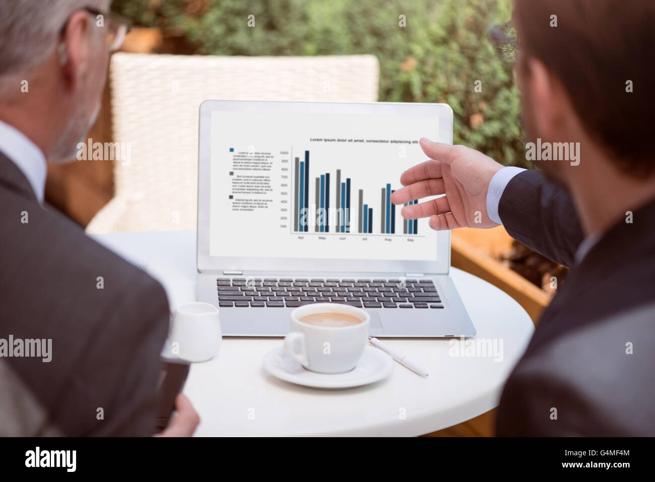 Colleagues sitting at the table Stock Photo - Alamy