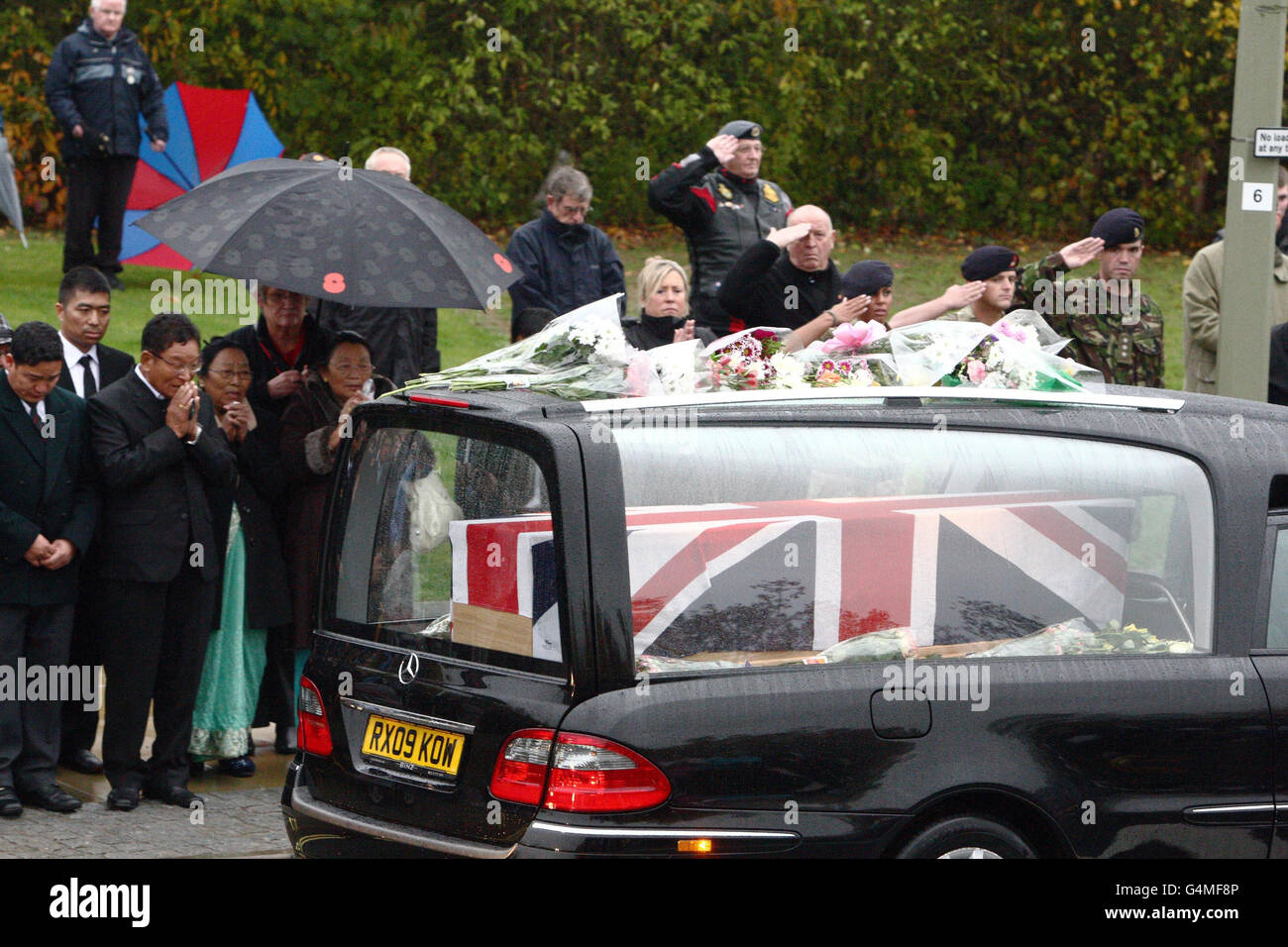 The family of Rifleman Vijay Rai and mourners stand at the road side in ...