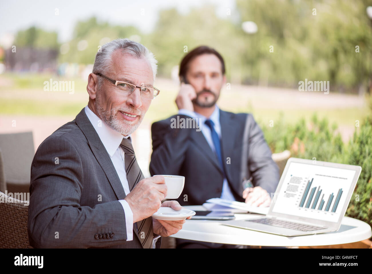 Cheerful man sitting at the table Stock Photo - Alamy