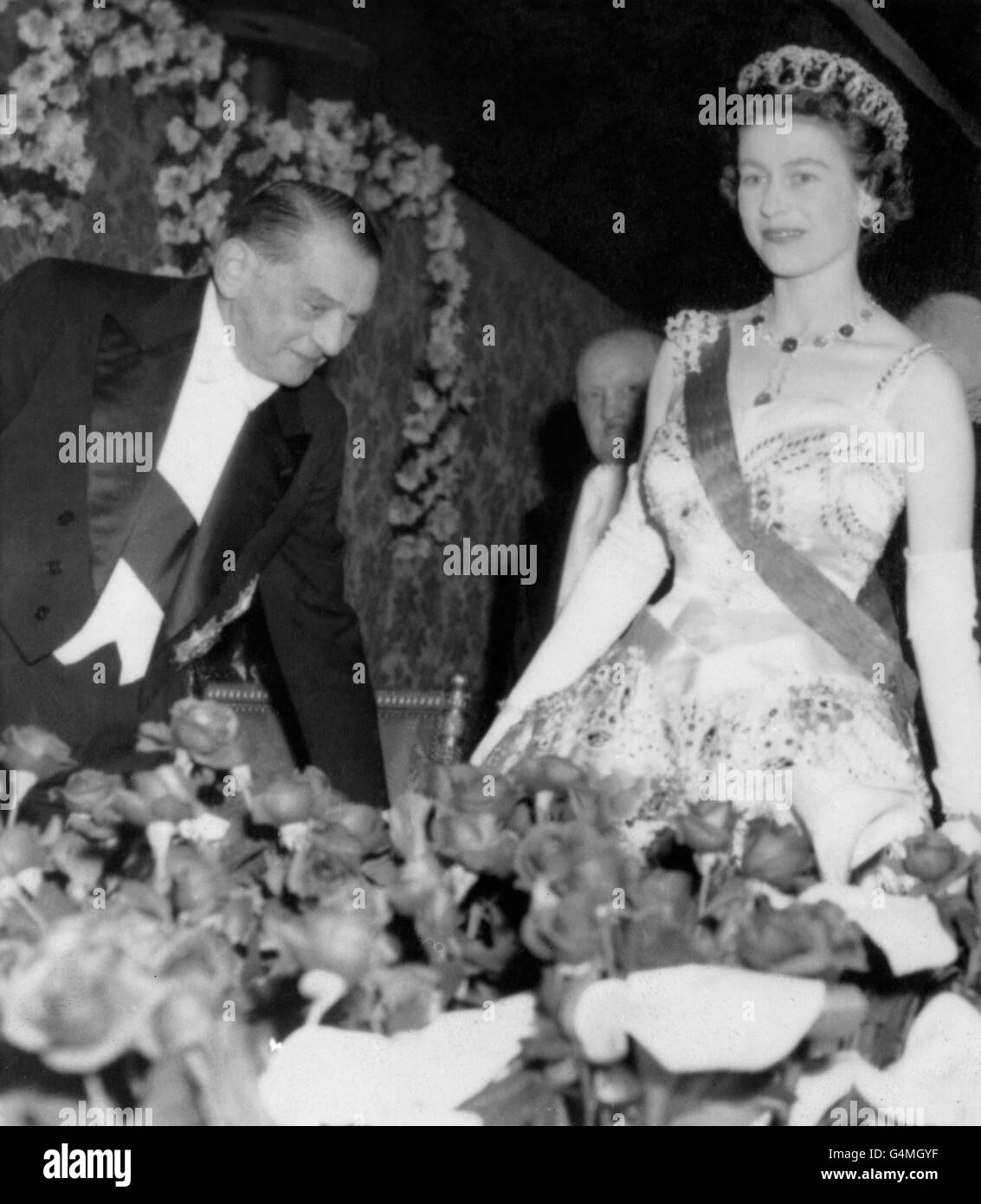 French President Rene Coty helps Queen Elizabeth II into her seat in ...